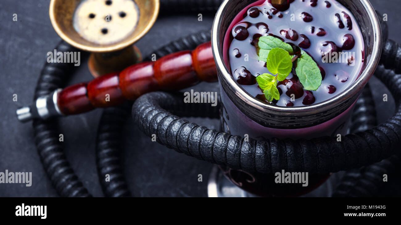 Smoking oriental shisha with alcohol berry cocktail Stock Photo - Alamy