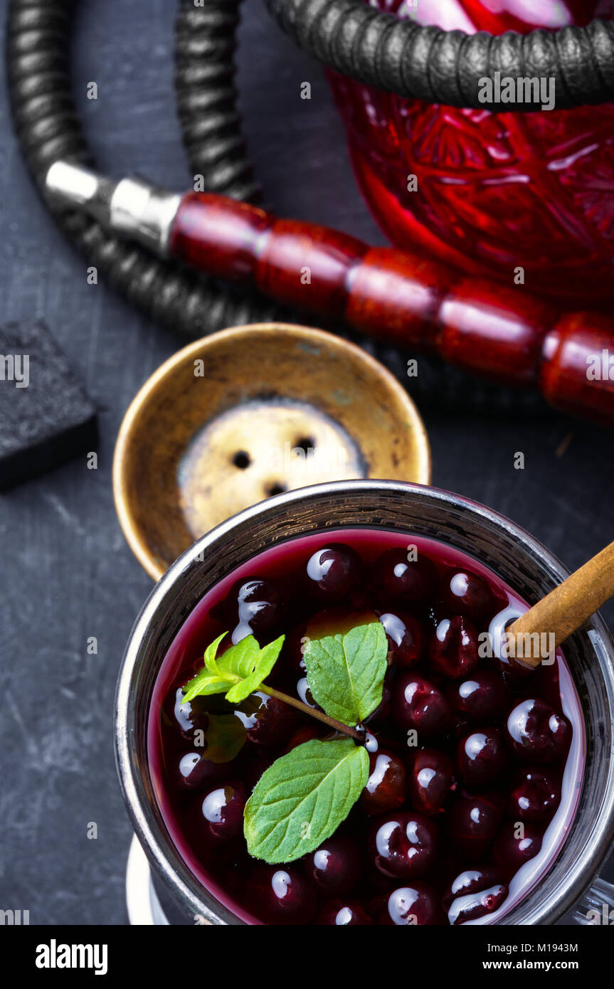 Smoking oriental shisha with alcohol berry cocktail Stock Photo - Alamy