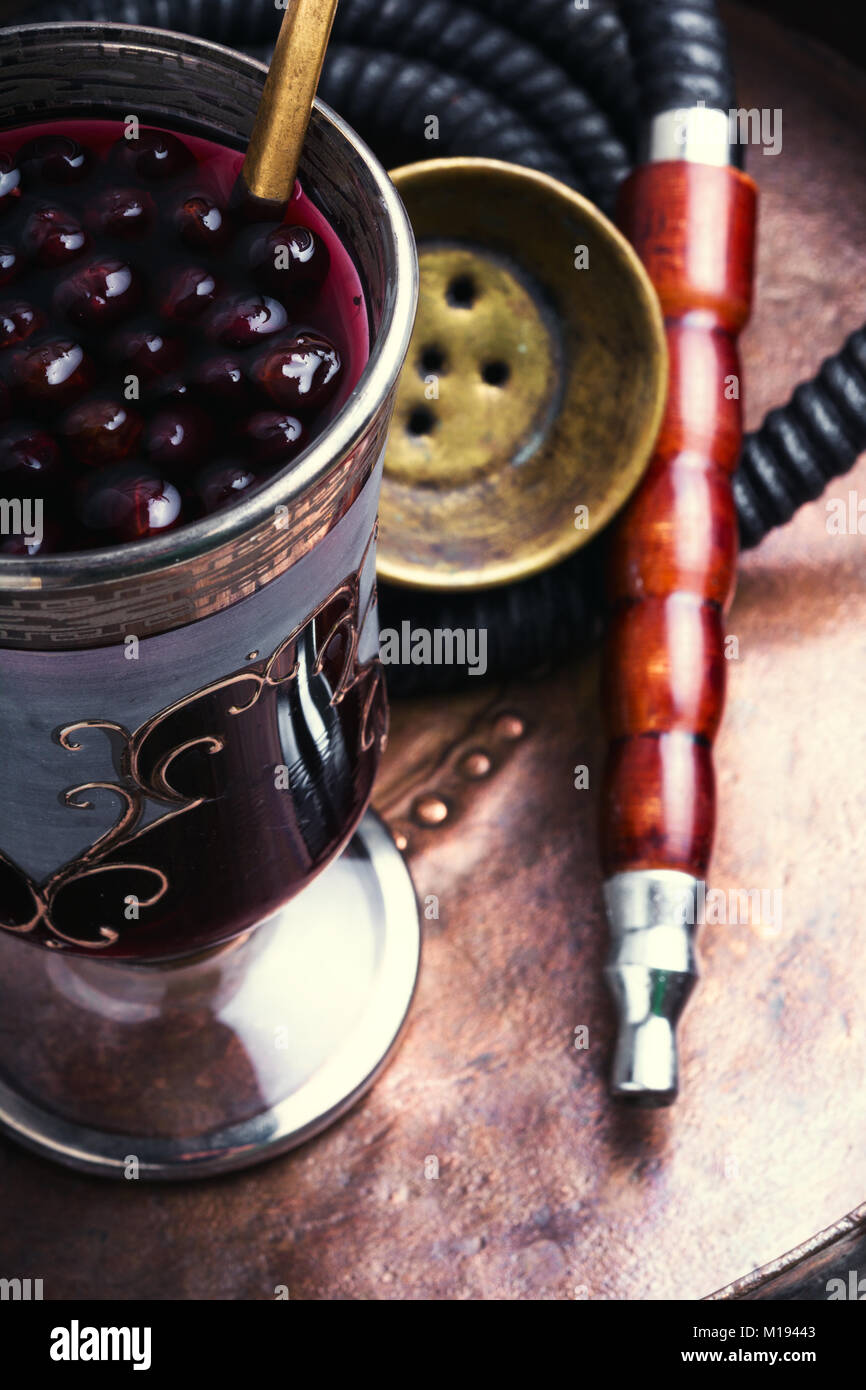 Smoking oriental shisha with alcohol berry cocktail Stock Photo - Alamy