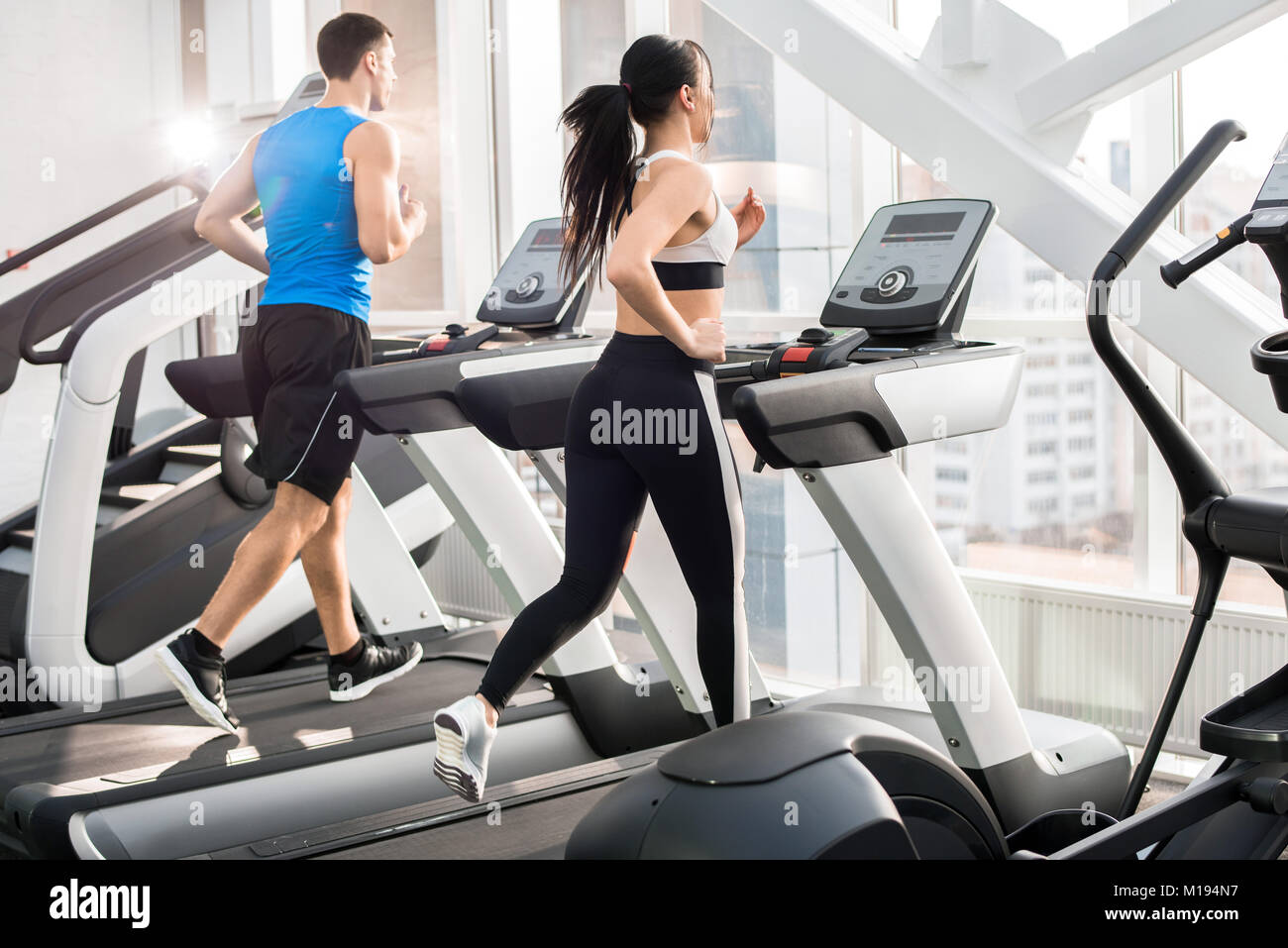 Beautiful woman running on treadmill hi-res stock photography and ...