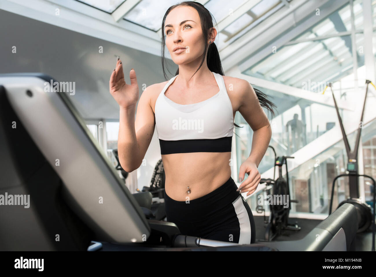 Young Woman Running on Treadmill Stock Photo - Alamy