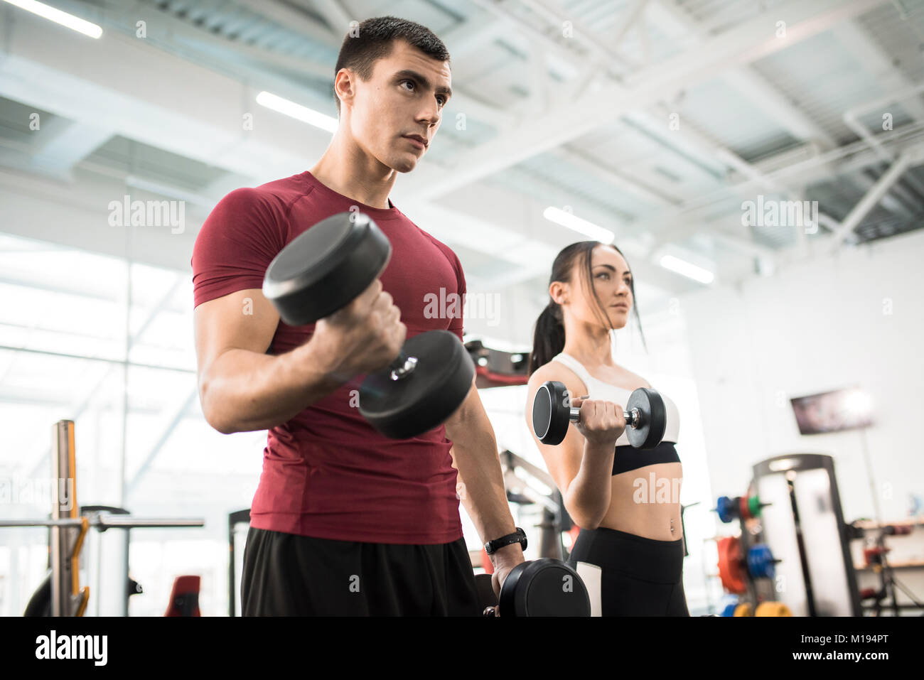 Couple Training with Weights in Gym Stock Photo - Alamy