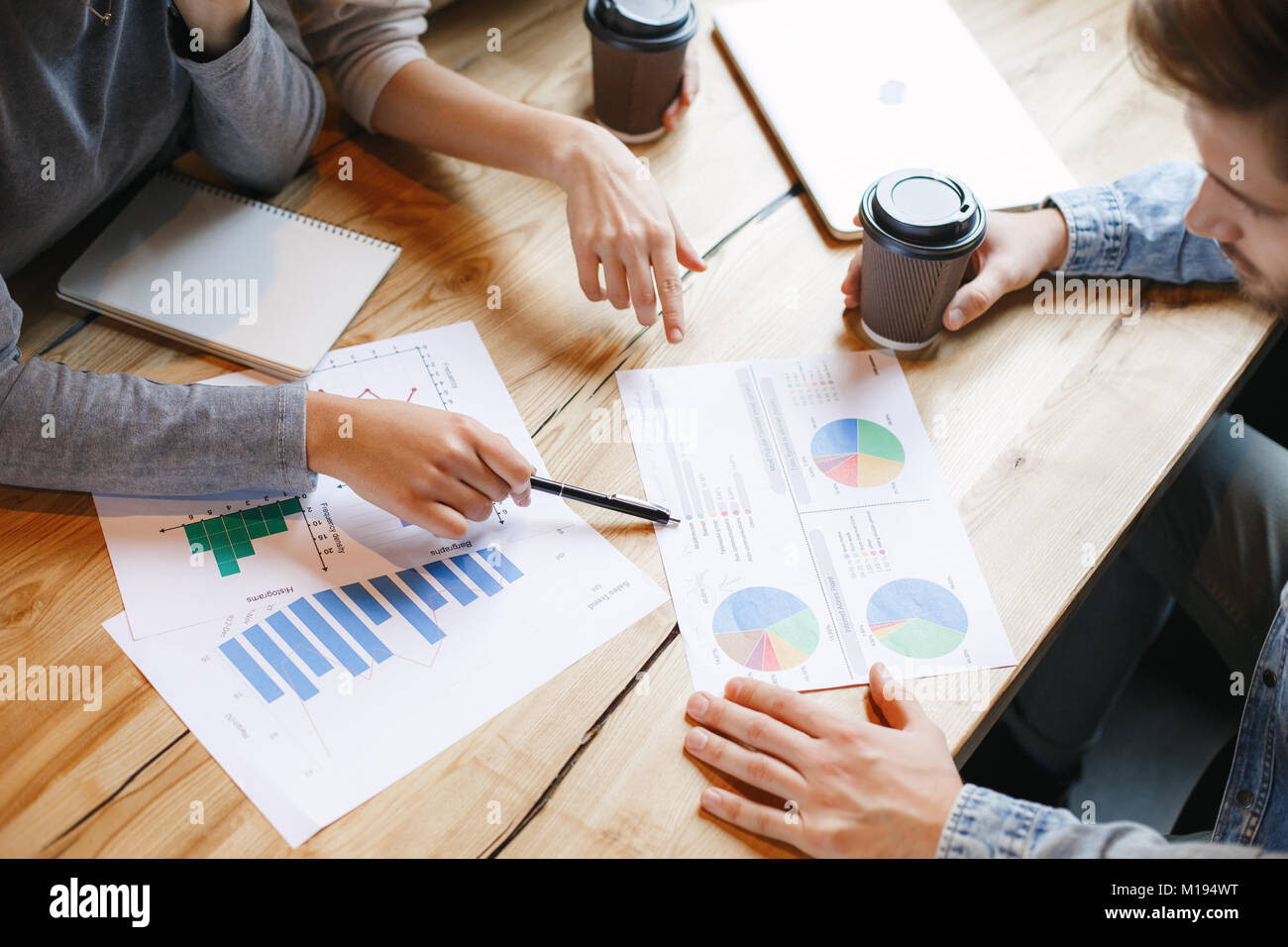 Group of students having a business lunch indoors discussing research ...