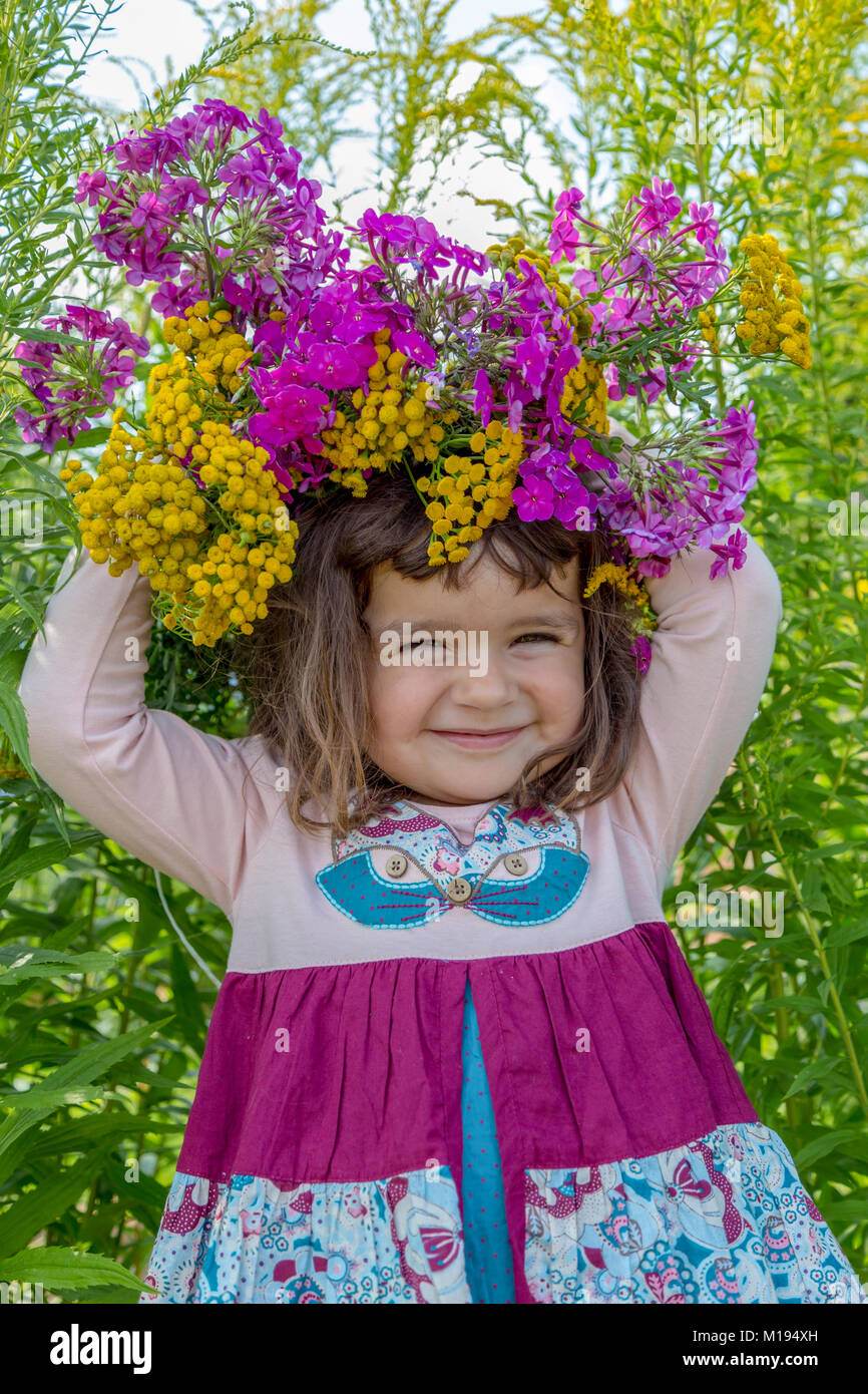 Girl playing on the flower field Stock Photo - Alamy