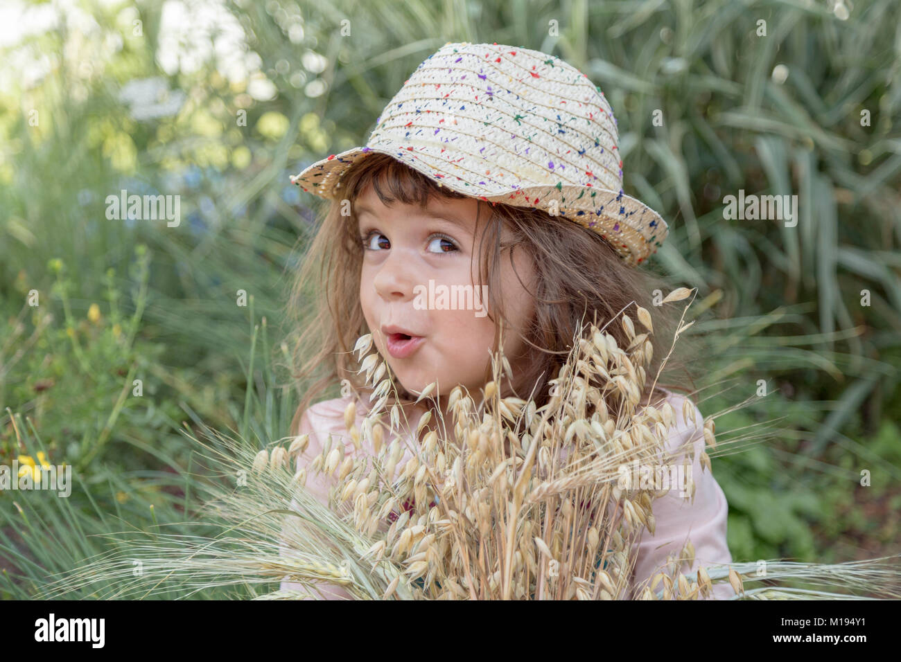 Girl playing on the flower field Stock Photo - Alamy