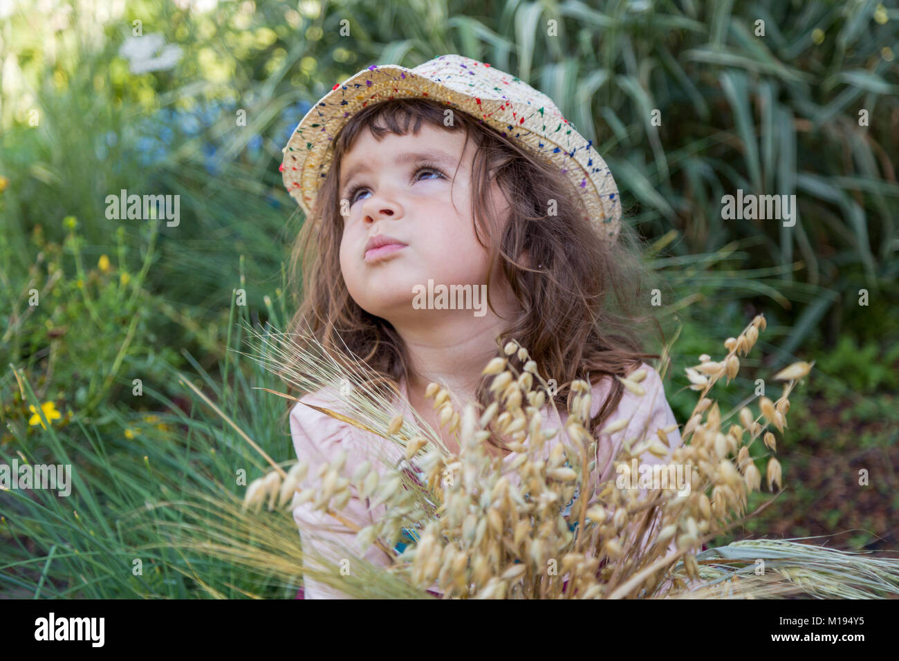Girl playing on the flower field Stock Photo - Alamy