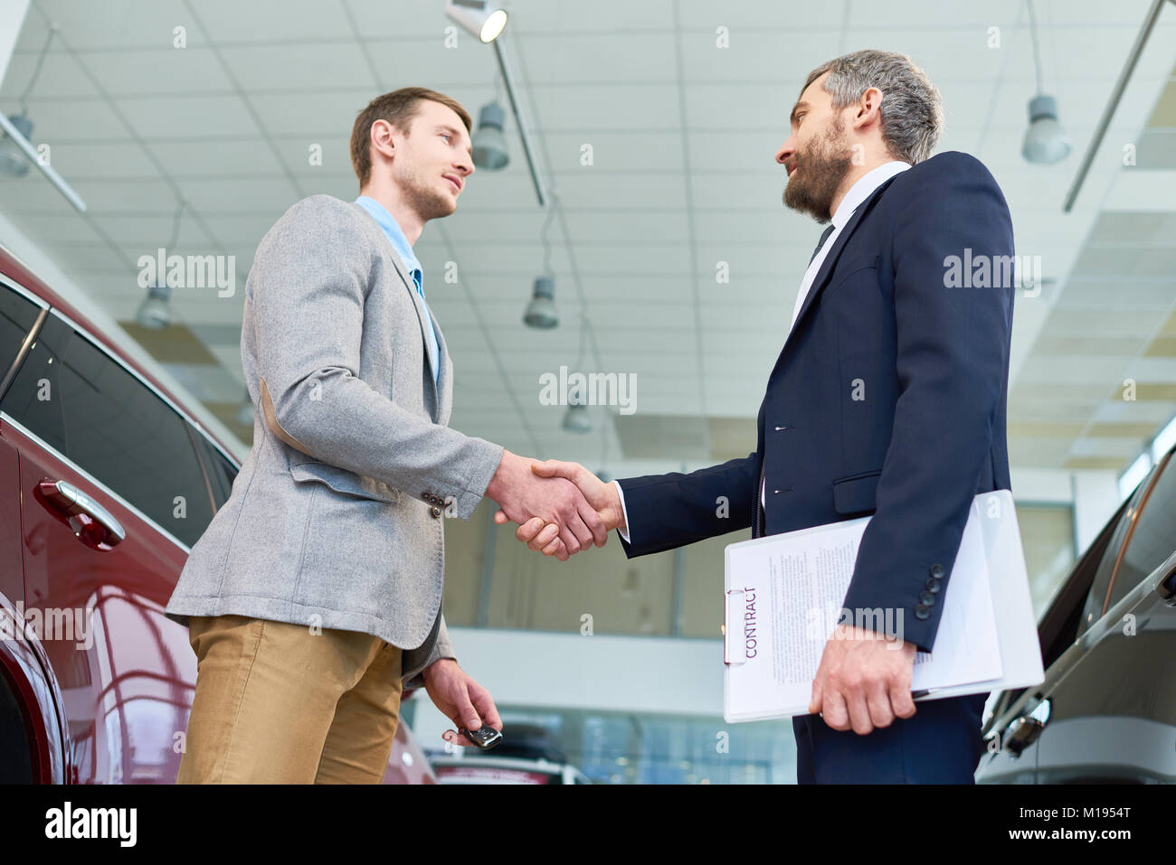 Man Buying Car in Showroom Stock Photo - Alamy