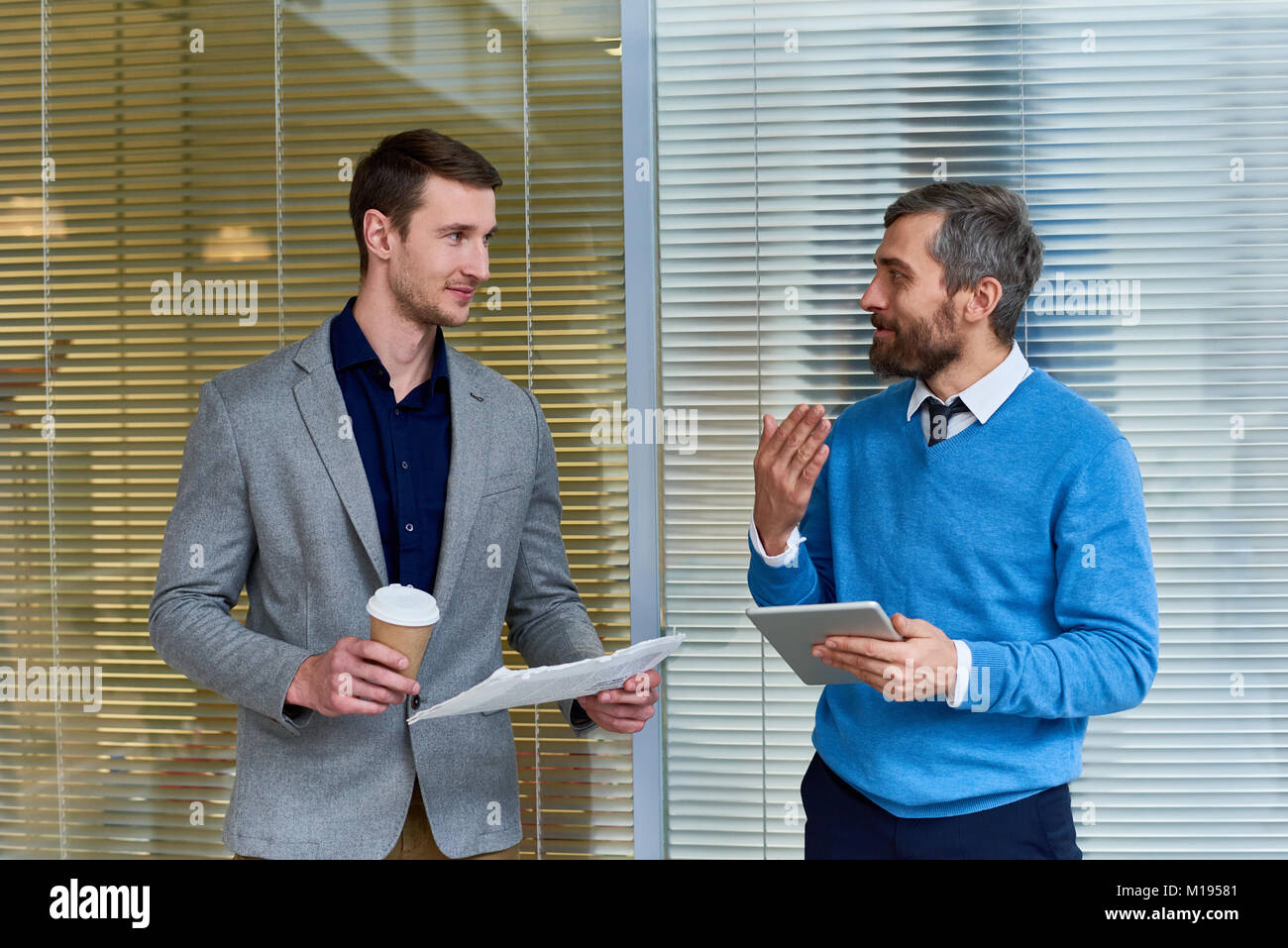 Business People Discussing News in Office Stock Photo - Alamy