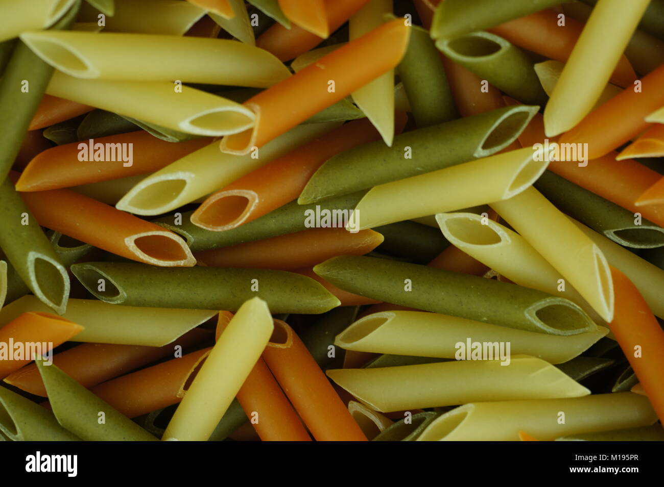 uncooked spaghetti tubes colored background of macro Stock Photo - Alamy