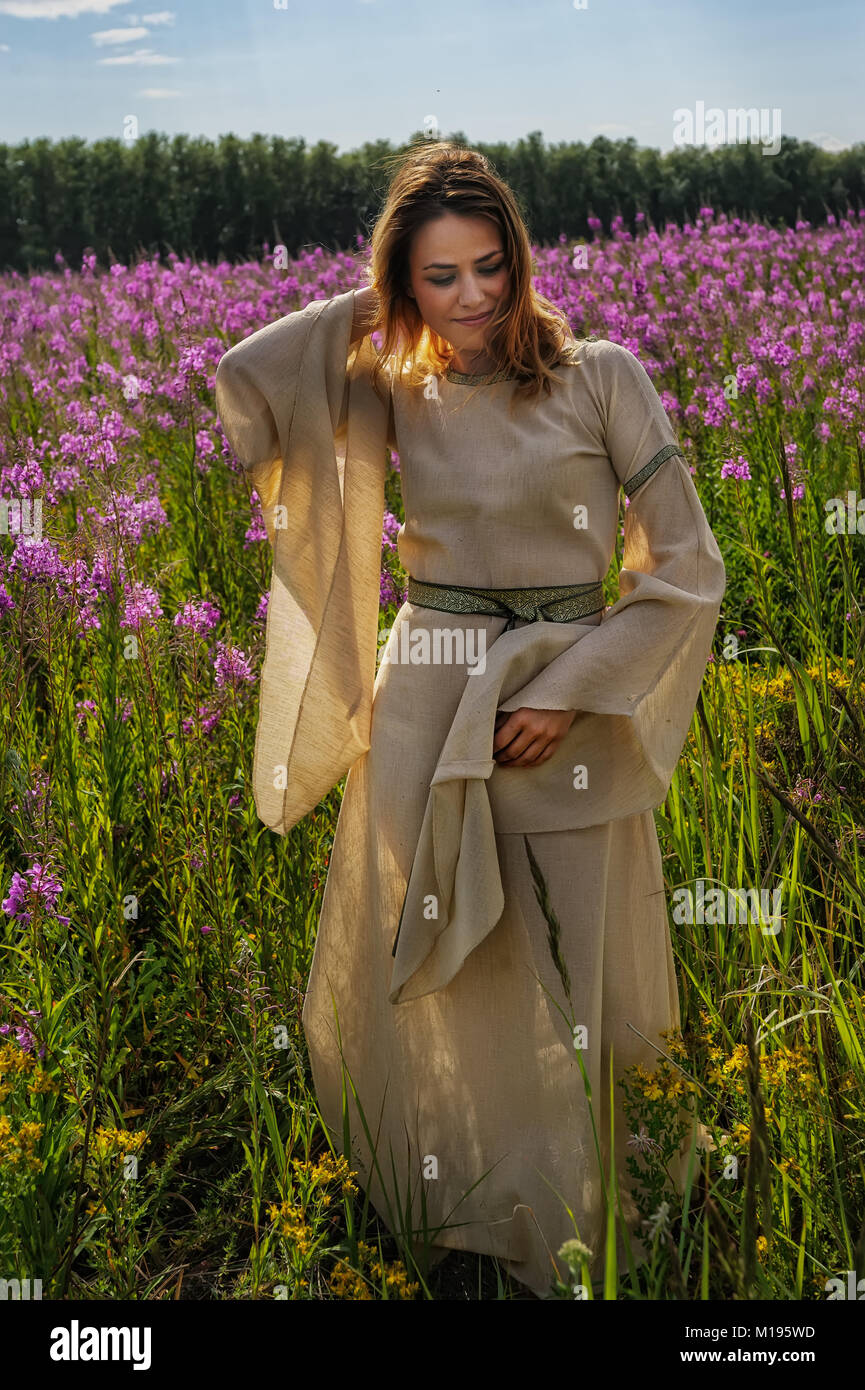 Attractive sad girl on meadow Stock Photo - Alamy