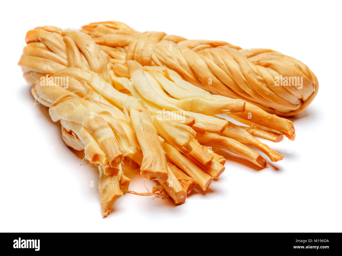 Smoked braided cheese isolated on white background Stock Photo - Alamy