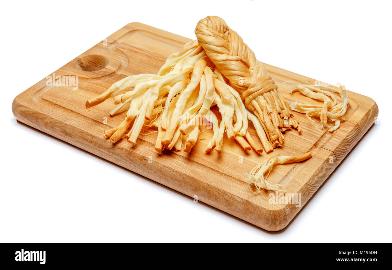 Smoked braided cheese isolated on white background Stock Photo - Alamy