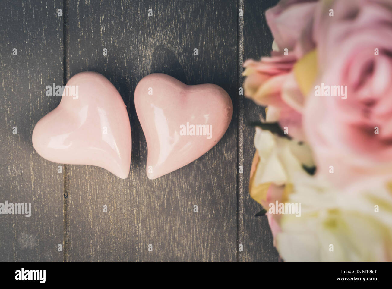 Two pink hearts and roses for Valentines Day on gray, retro toned Stock ...