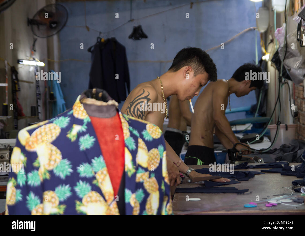 tailor man making clothes in textile workshop in Vietnam Stock Photo ...