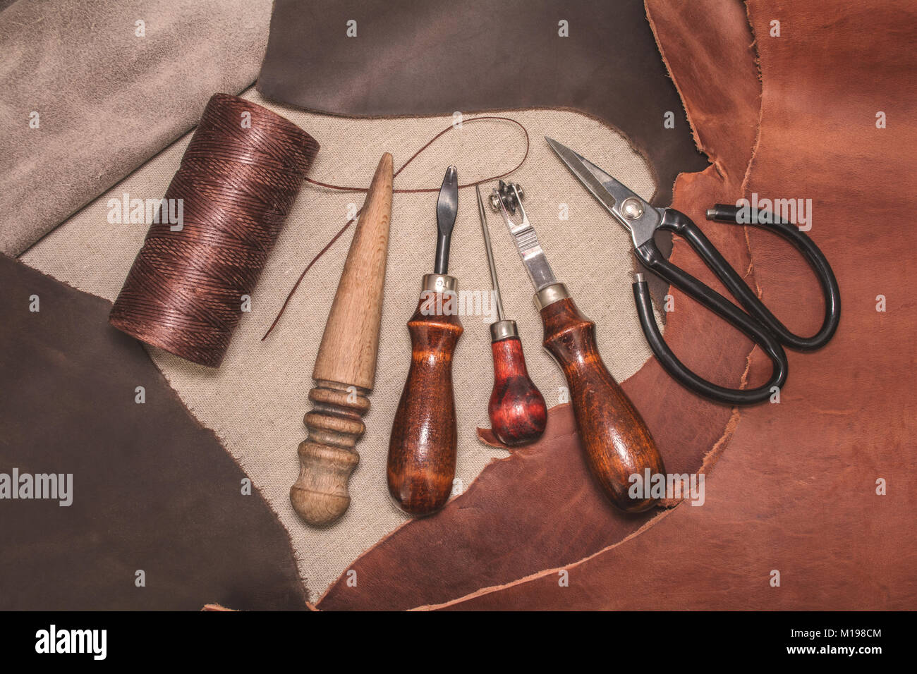 Tools for leather crafting and pieces of brown leather. Manufacture of ...
