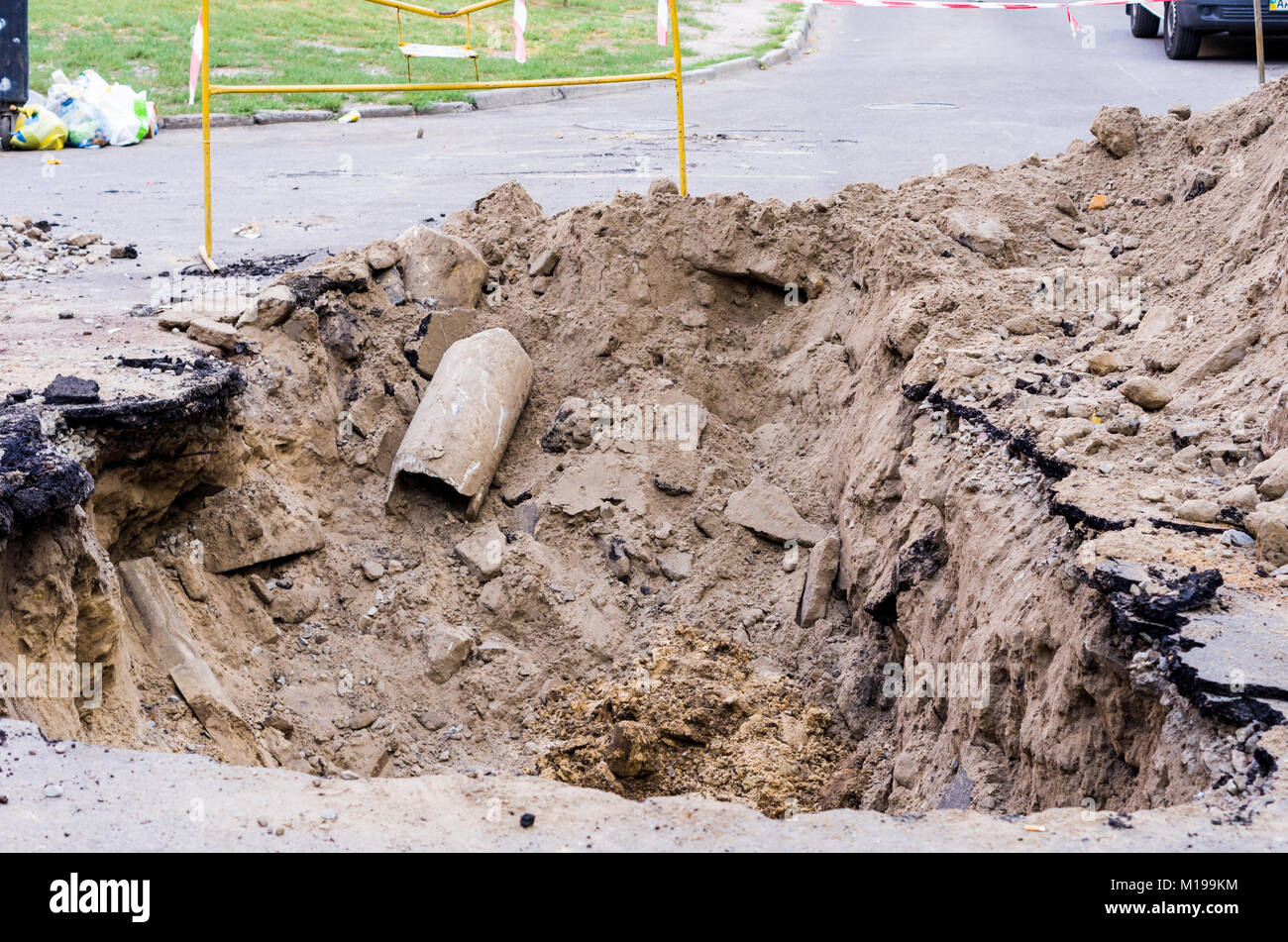 A dug hole in the street. Repair of the street. Asphalt and sand Stock ...