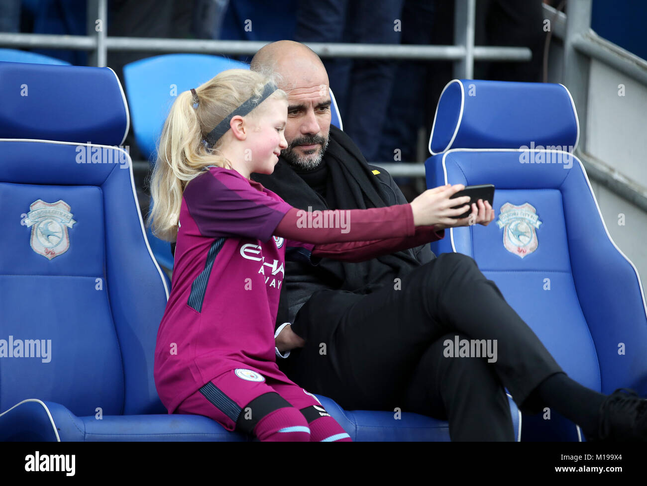 Manchester City manager Pep Guardiola poses for photographs with fans ...