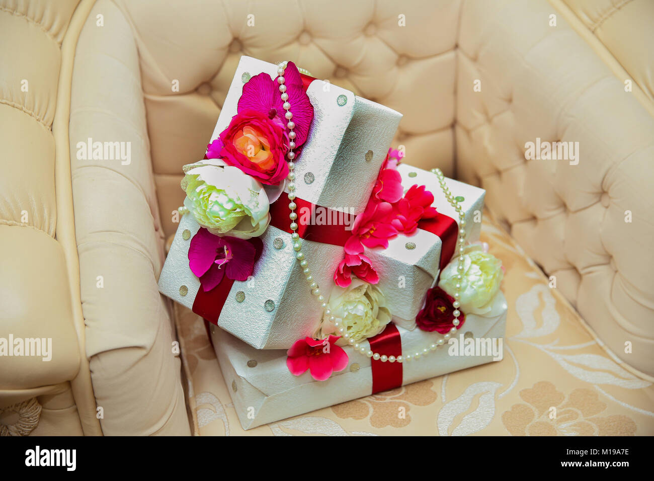 White and pink roses and white pearls on top. Two white engagement ...