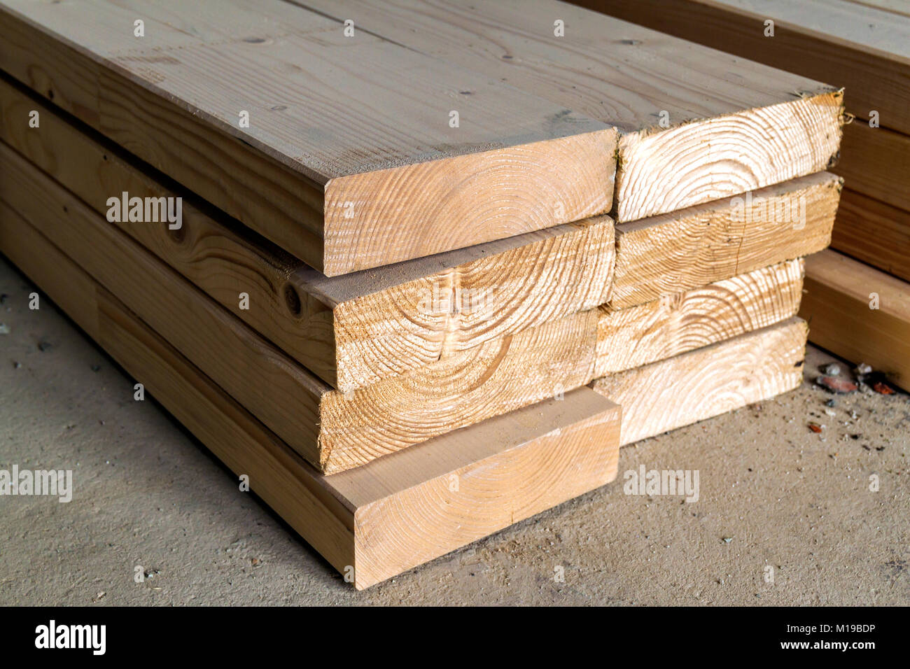 Stack of new wooden studs at the lumber yard. Wood timber construction ...