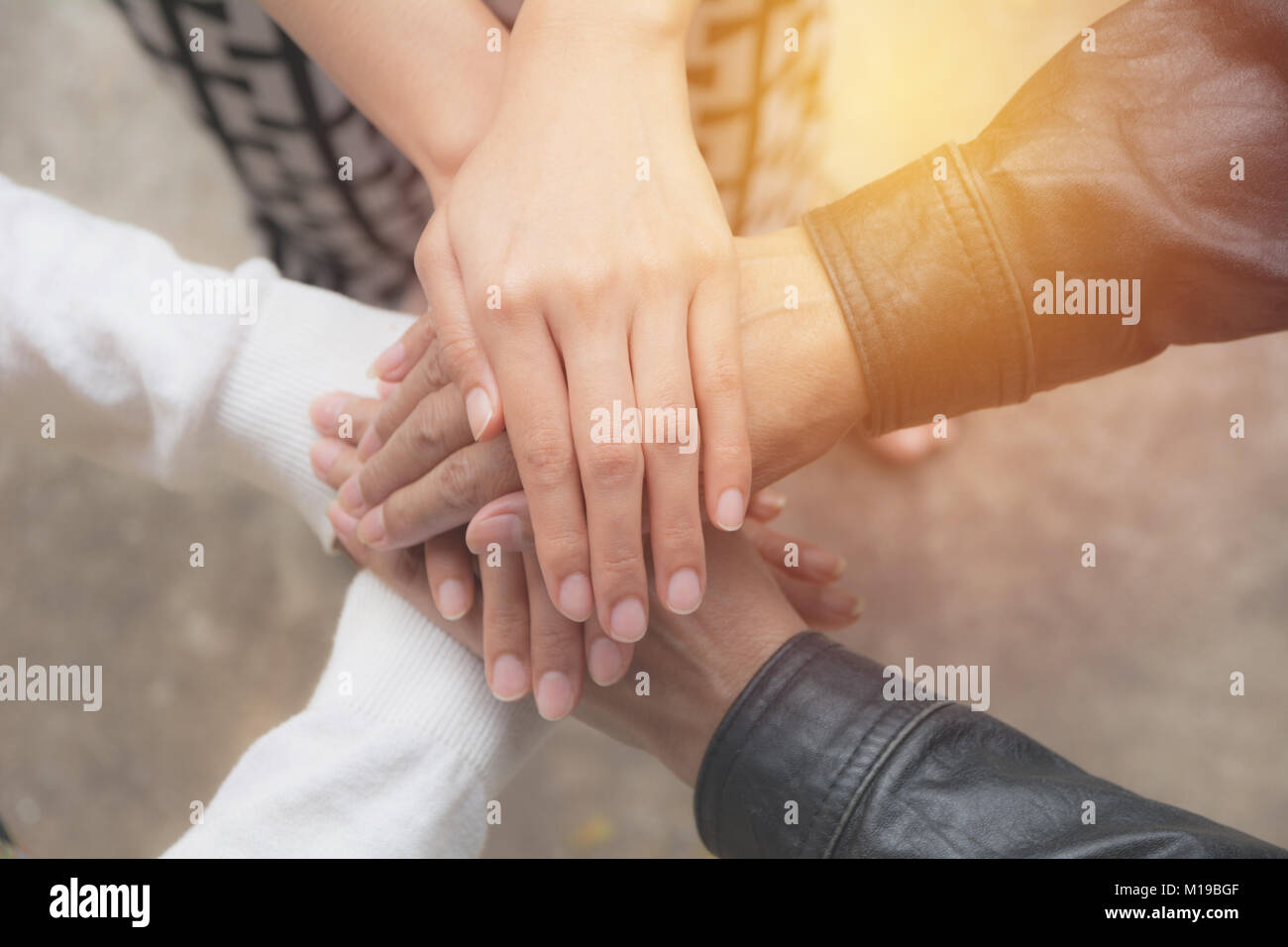 Close up of people putting their hands together. Stack of hands unity ...