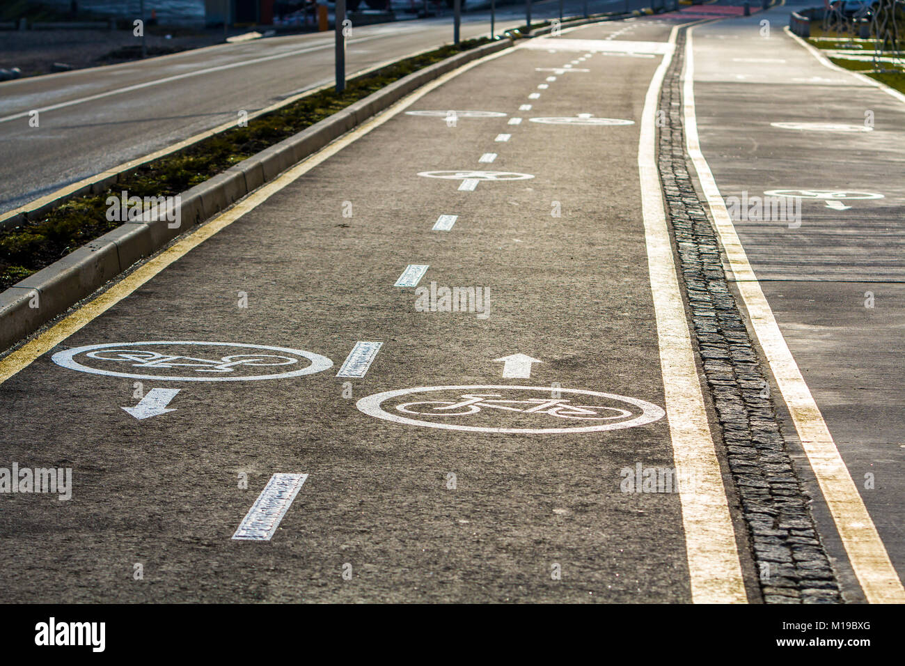 Walk way and bicycle lane signs on the asphalt road surface Stock Photo ...