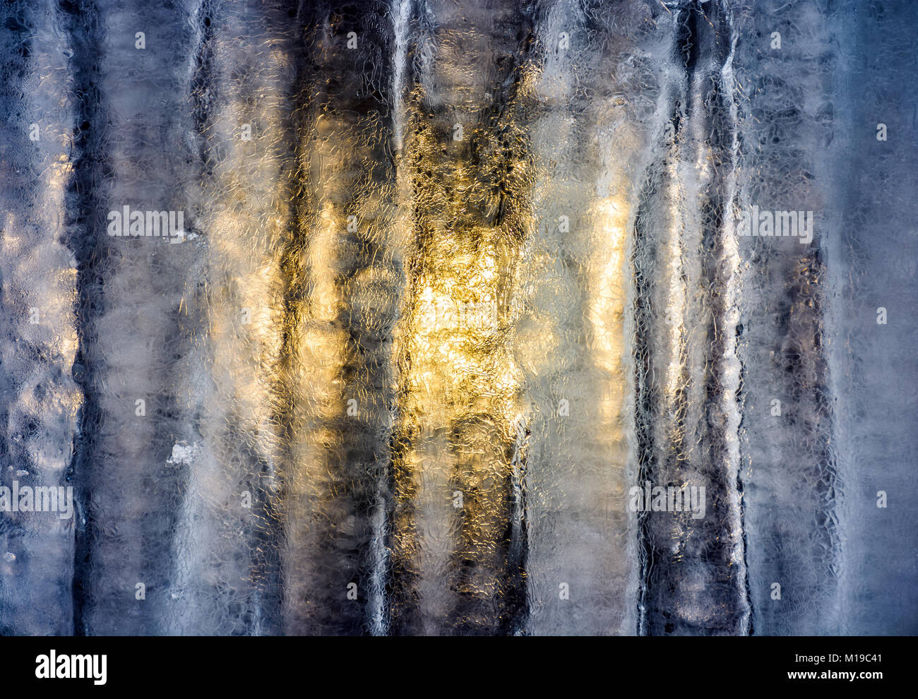 sun behind the ice wall. beautiful winter background with fine frosted ...