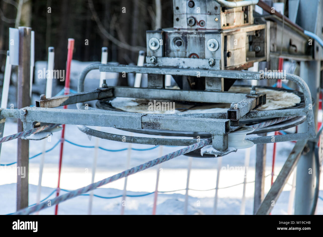 The mechanism of the ski lift. Rotating wheel of elevator on snowy hill ...