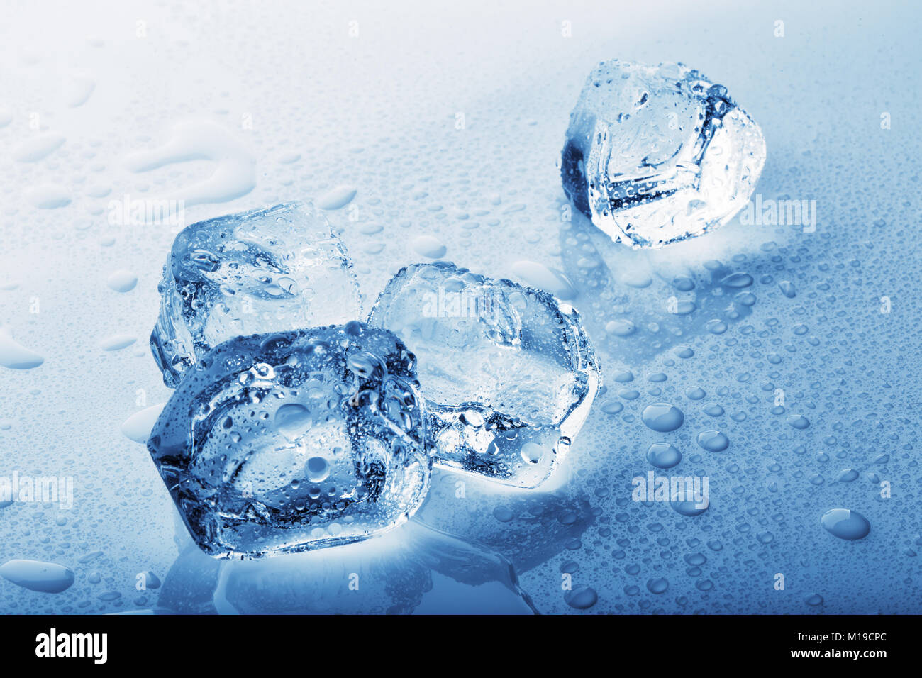 Four ice cubes on wet background with drops of water Stock Photo - Alamy