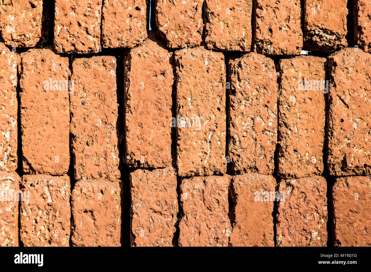 a red bricks folded in a row. Construction material ready for ...