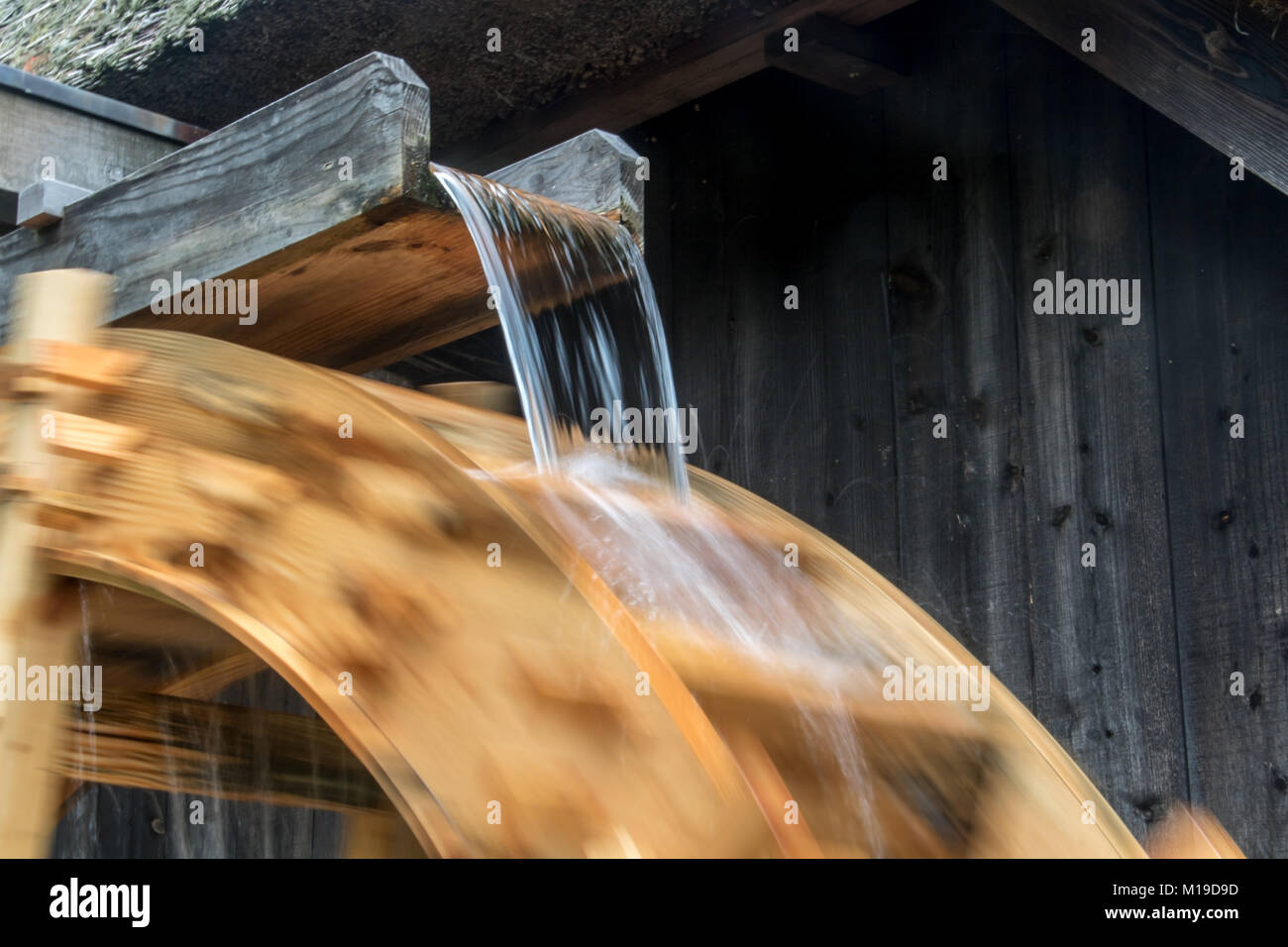 The part of mill wheel rotates under a stream of water, open air museum ...