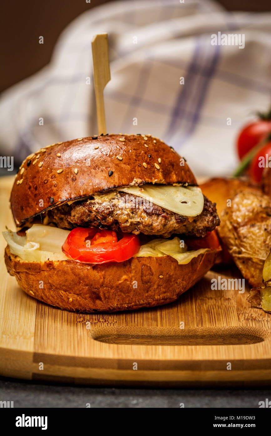 Traditional Cheeseburger with beef meat and fried potato Stock Photo ...