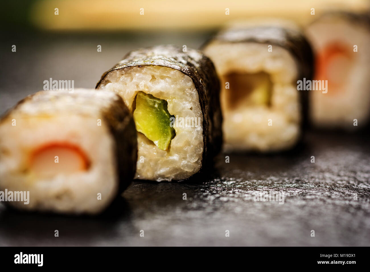 Traditional japanese sushi rolls hosomaki on stone desk Stock Photo - Alamy