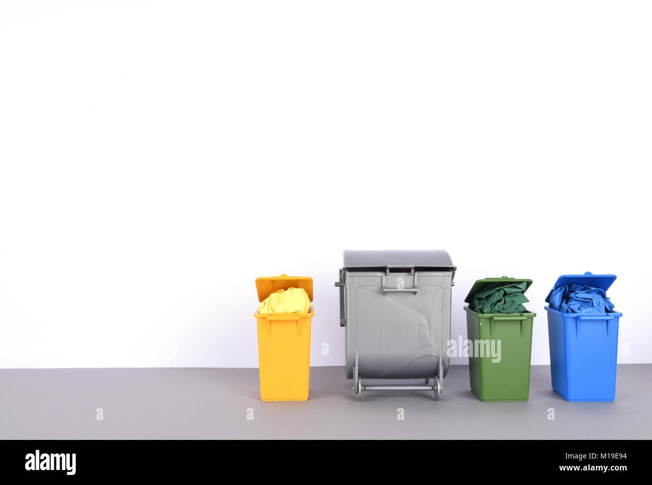Colorful recycle bins on white background Stock Photo - Alamy