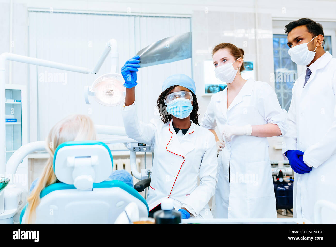 dental team checking teeth x ray of patient Stock Photo - Alamy