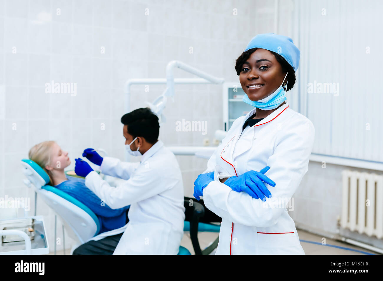 African american female dentist treating patient at clinic Stock Photo ...