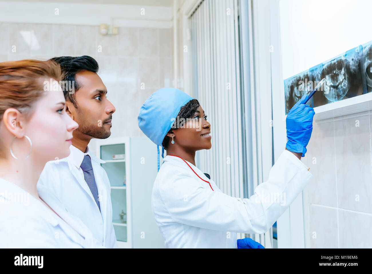 dental team checking teeth x ray of patient Stock Photo - Alamy