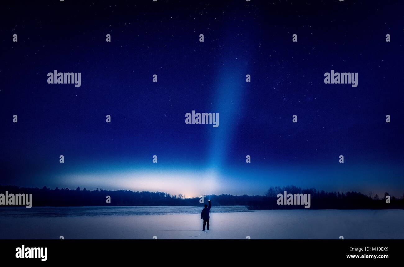 Surreal night landscape with alone strange man with flashlight. Horror ...