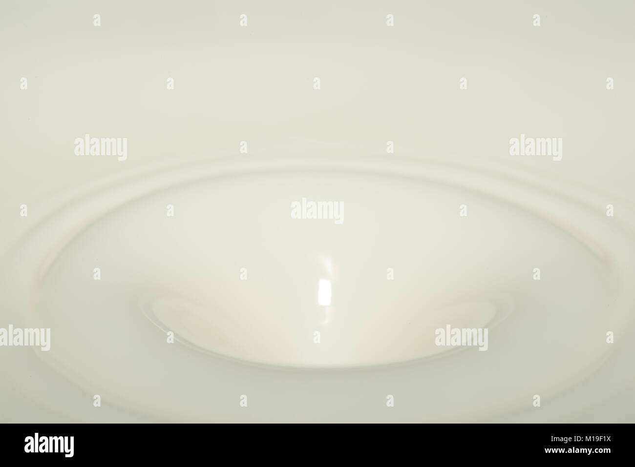 milk drops in milk - forming a whole Stock Photo - Alamy