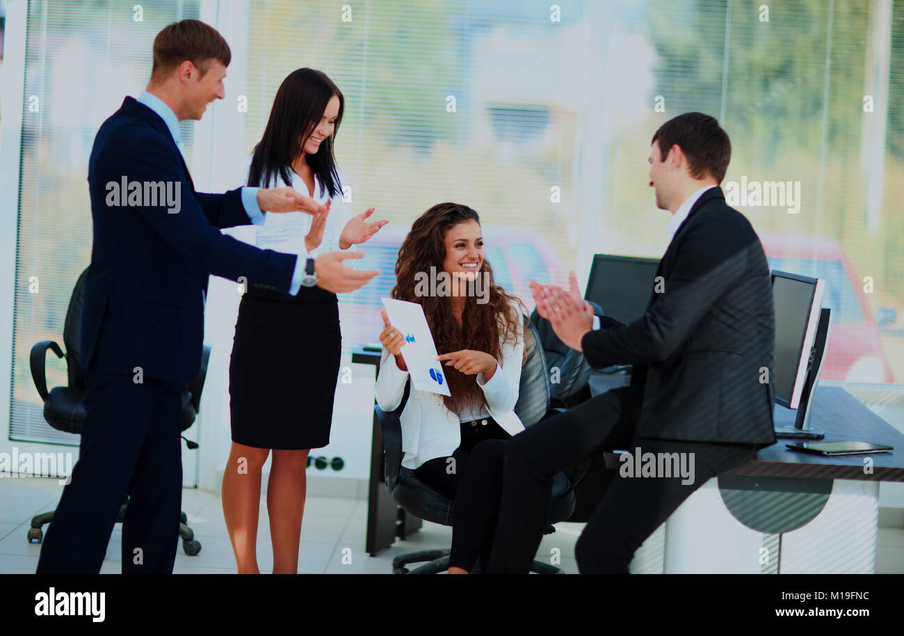 Colleagues clapping female colleague hi-res stock photography and ...