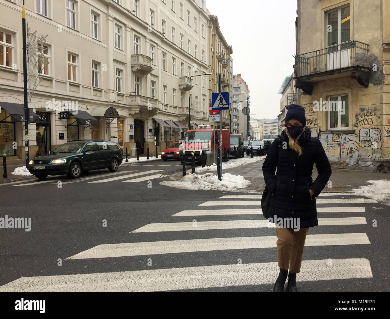 Warsaw, Poland. 24th Feb, 2017. A young woman wearing a smog mask ...