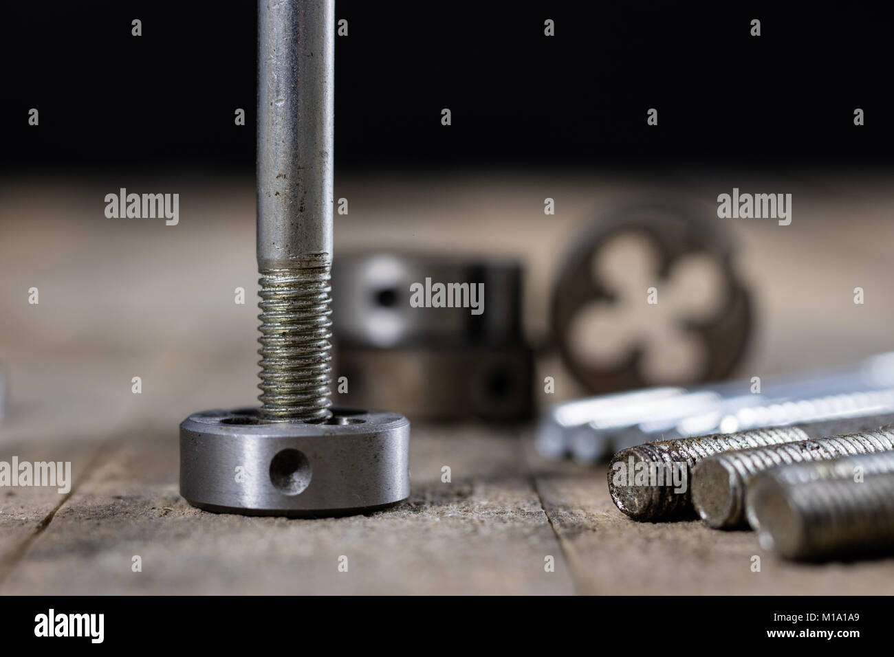Metalwork tools on the workshop table. Threading dies and taps in an ...