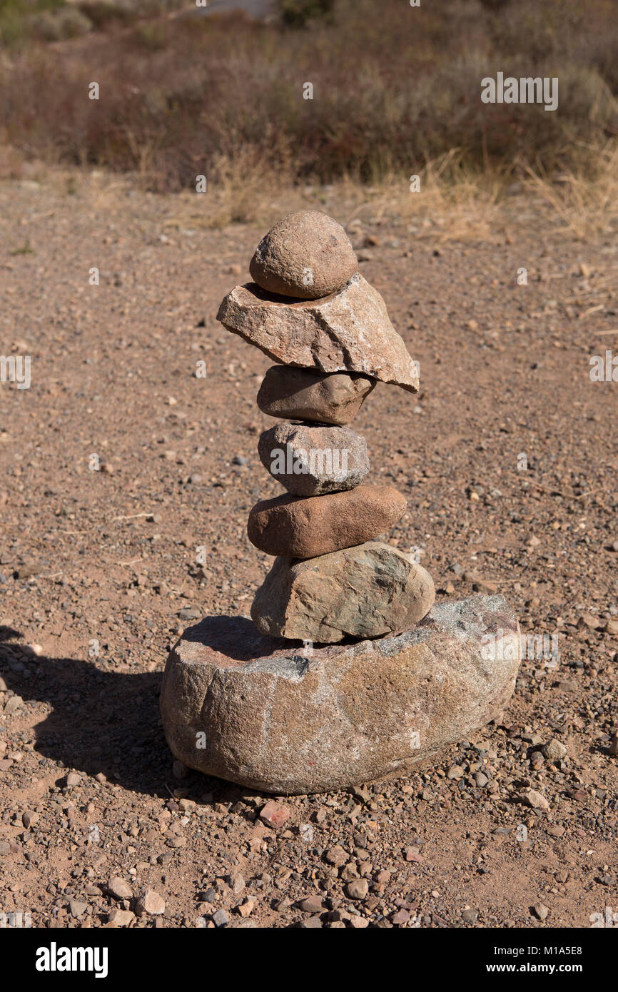 A tranquil scene of a balancing rock or stone pile stacked on top of ...
