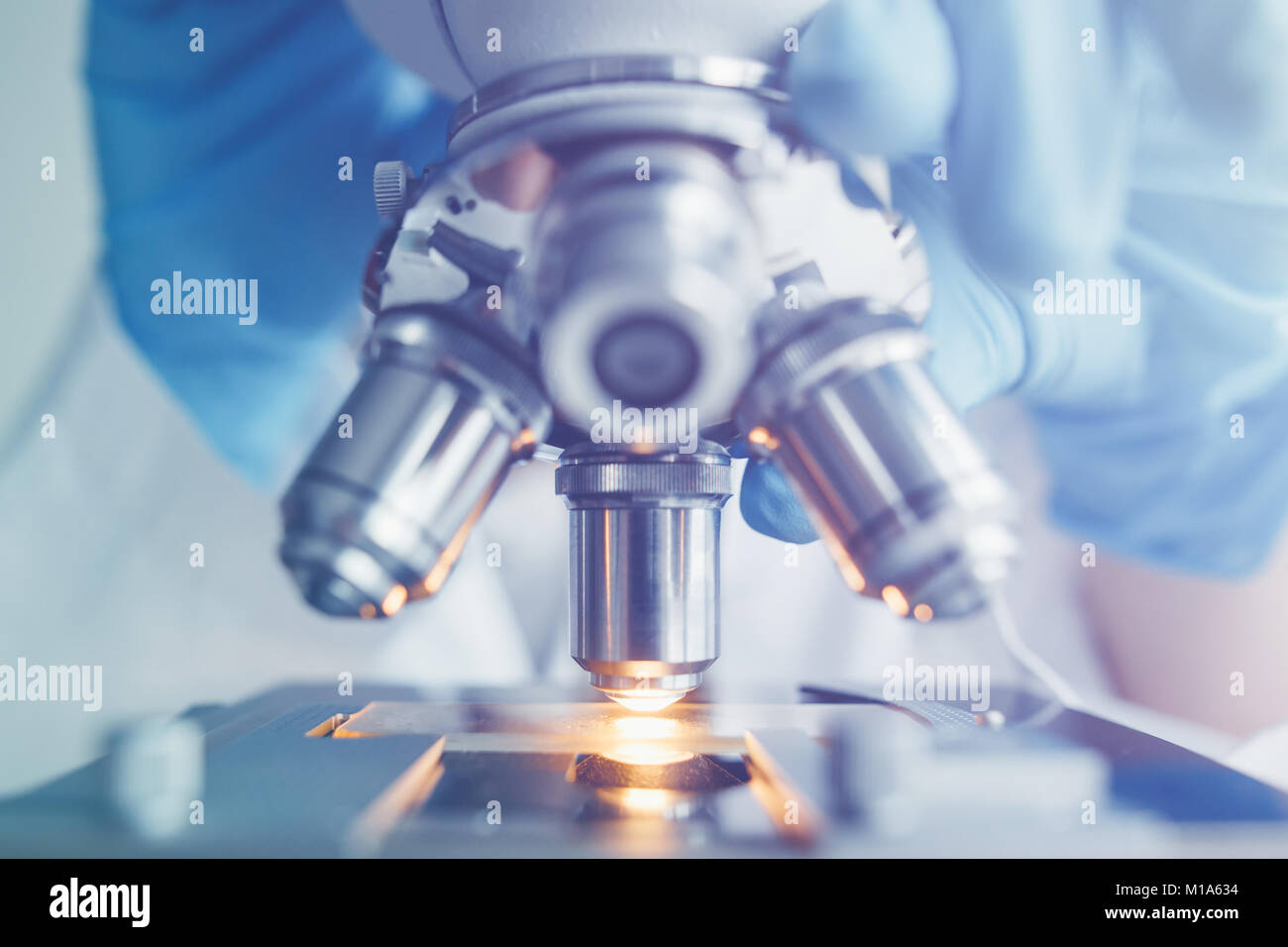 Close up of examining of test sample under the microscope Stock Photo ...