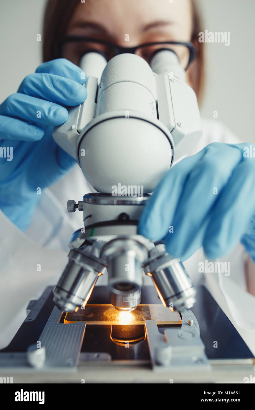 Close up of examining of test sample under the microscope Stock Photo ...