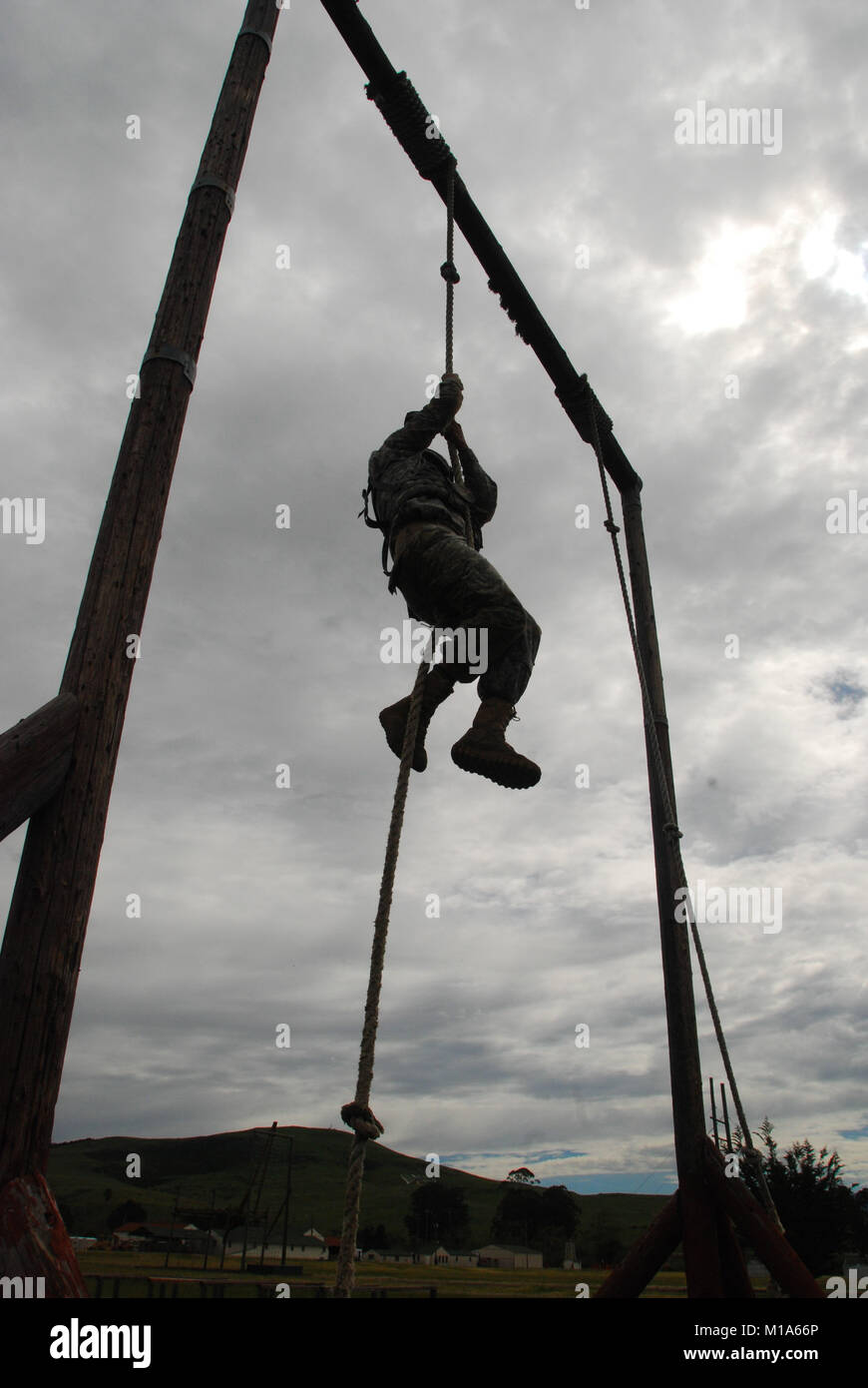An Army National Guard troop begins his ascent to the top of the rope ...