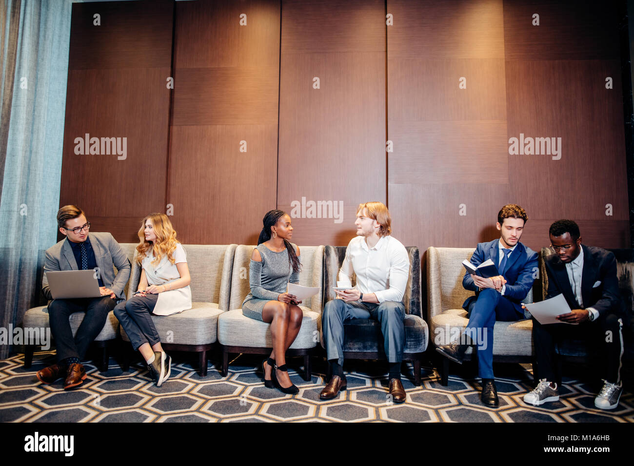 Business people waiting for job interview, talking Stock Photo - Alamy