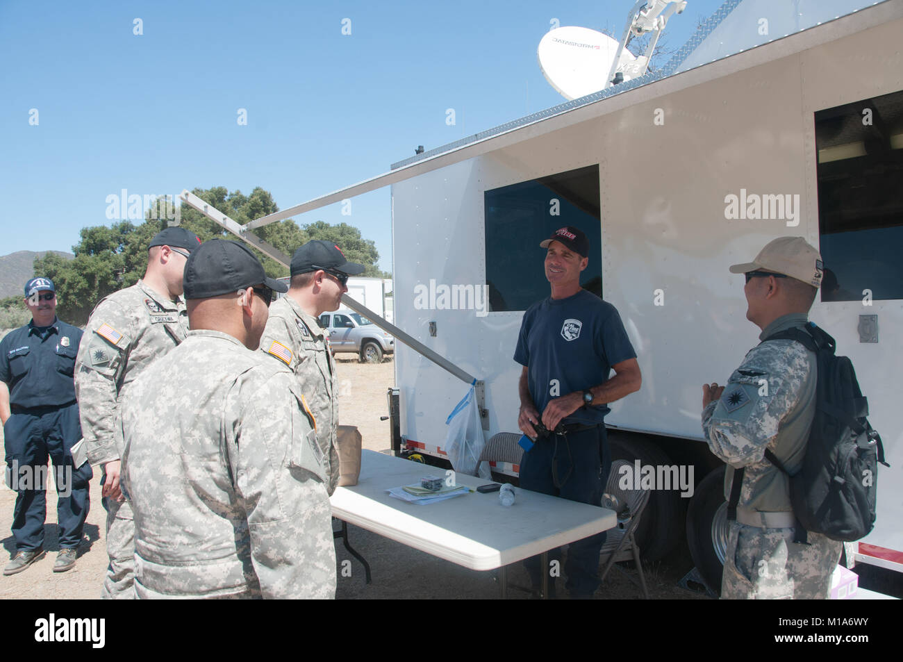 Tim Stepovich, Helibase manager for CAL FIRE, center, discusses the ...