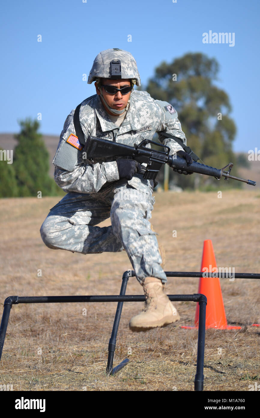 120910-Z-DH635-005 SGT Luis Mendoza moves tactically over the hurdles ...