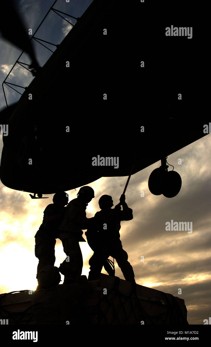 Riggers from the 10th Special Forces Group (Airborne) prepare to hook ...