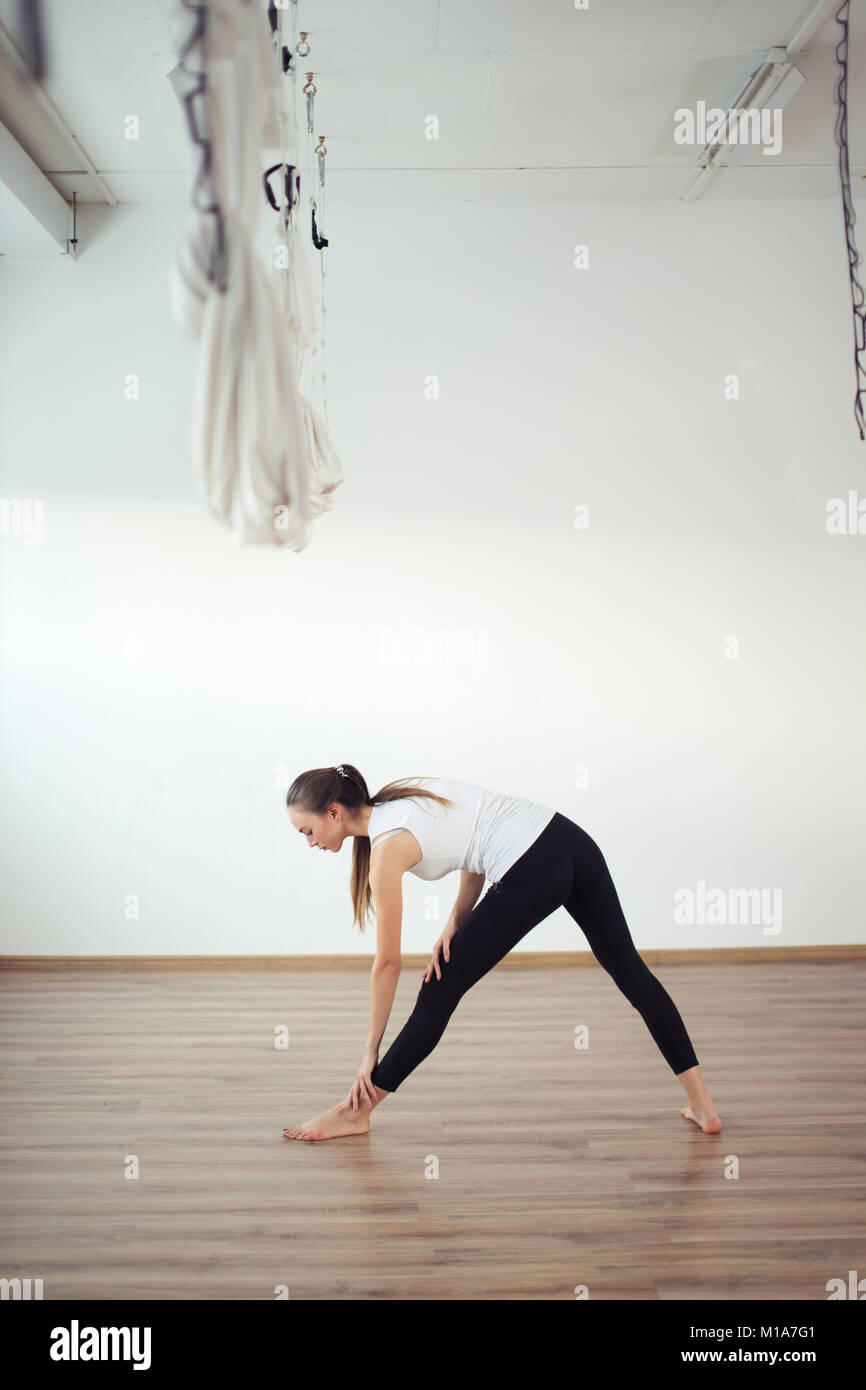 young woman enjoying yoga indoors. Revolved Triangle Pose, Parivrrta ...
